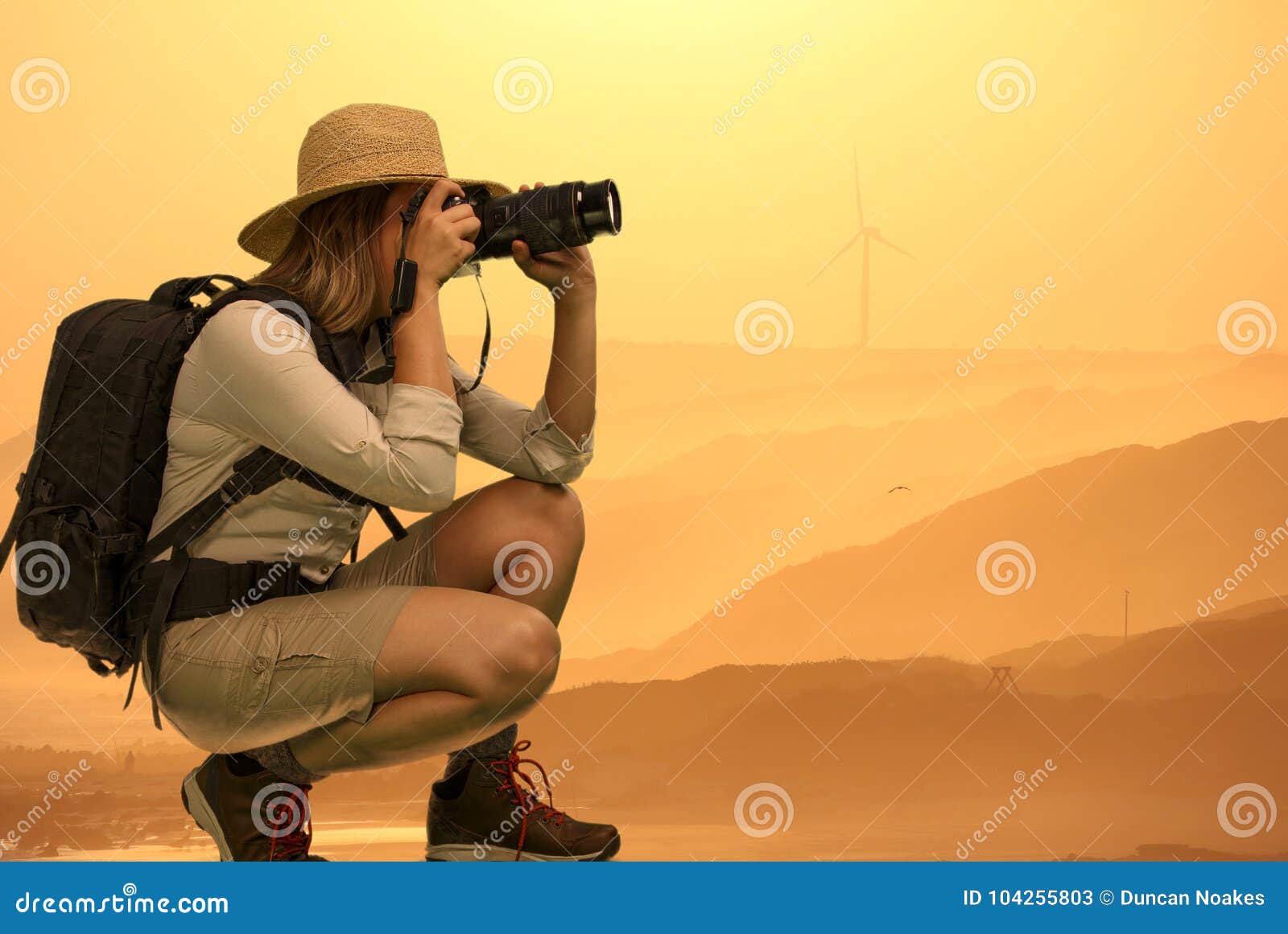 Lady In Safari Attire Taking Photographs Of African Wildlife Royalty Free Stock Image
