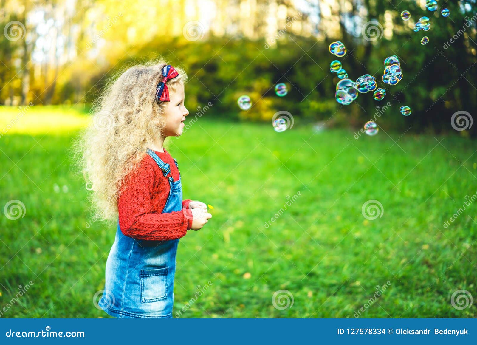 Pretty Little Girl Blowing Bubbles in the Park. Stock Photo - Image of ...
