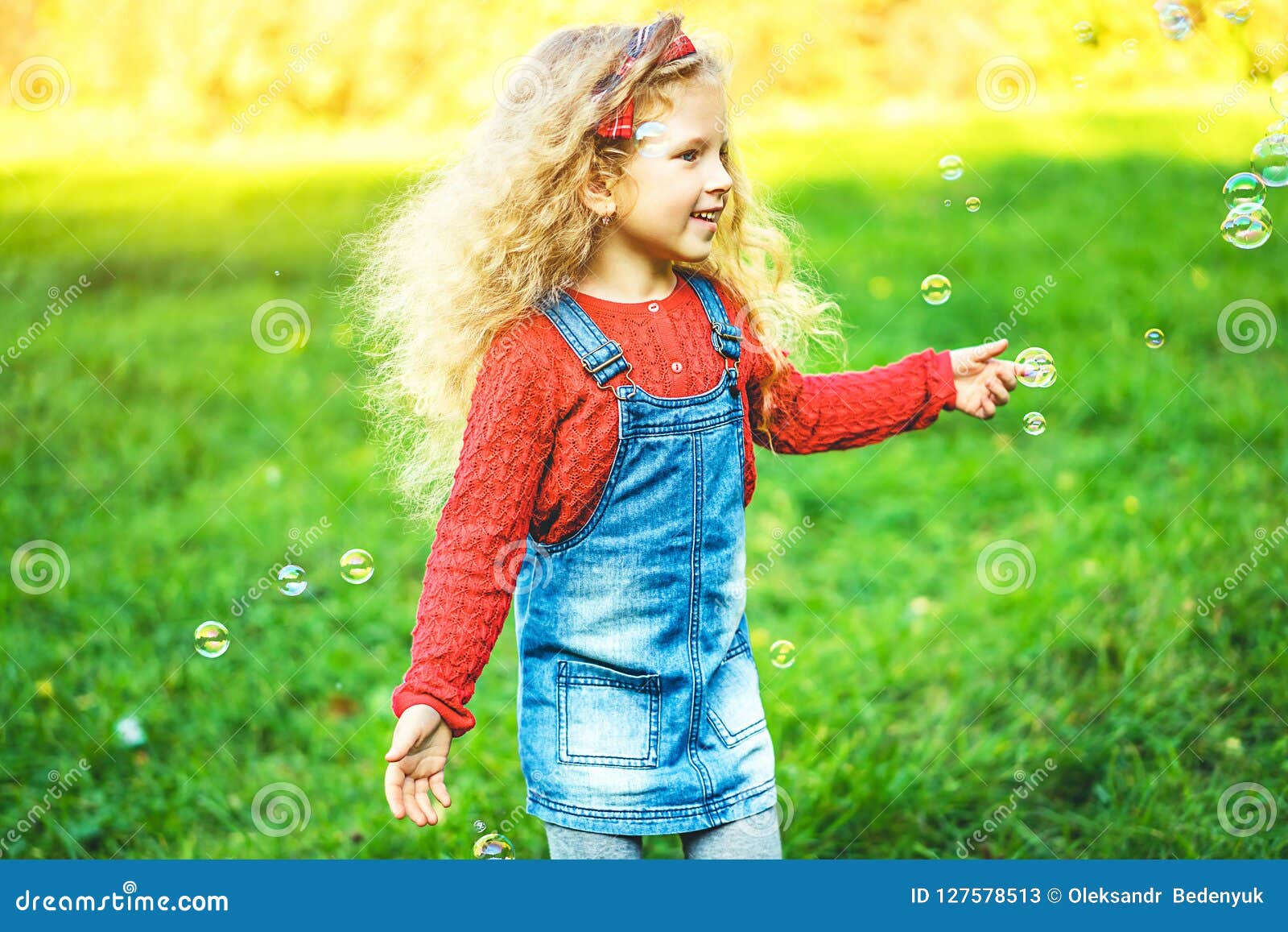 Pretty Little Girl Blowing Bubbles in the Park. Stock Image - Image of ...