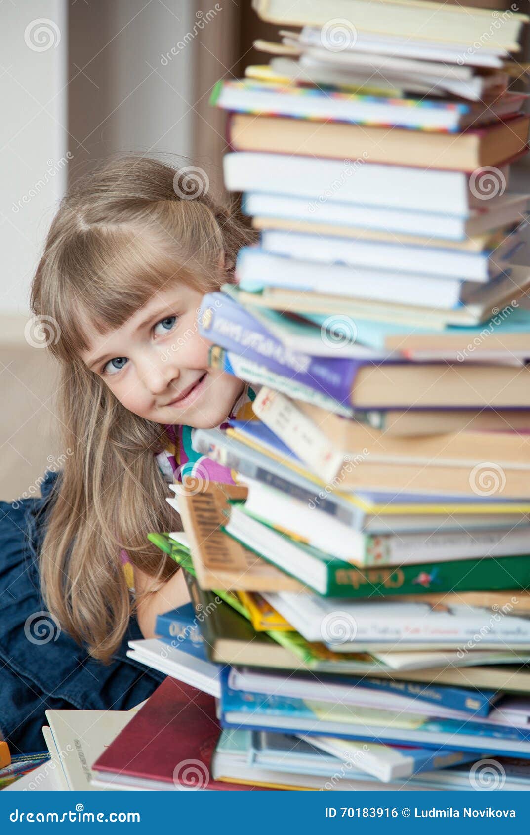 Pretty Little Girl Hiding Behind a Stack of Books Stock Photo - Image ...