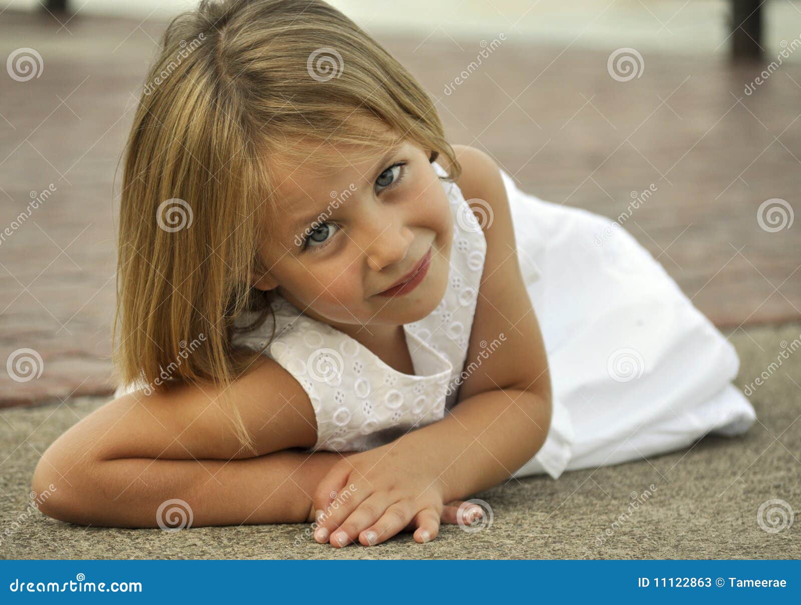 Pretty Little Girl Laying Down Outdoors Stock Image - Image of lovely ...