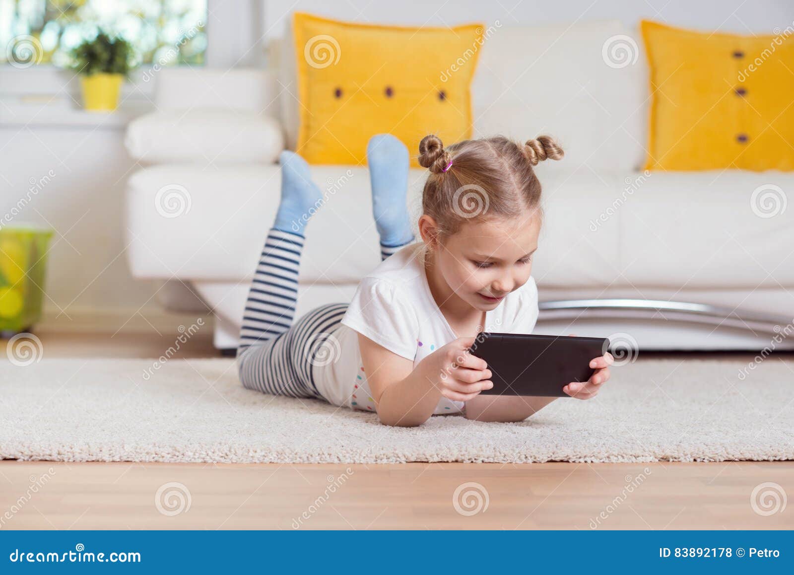 Pretty Little Girl Using a Digital Tablet, Looking and Smiling Stock ...