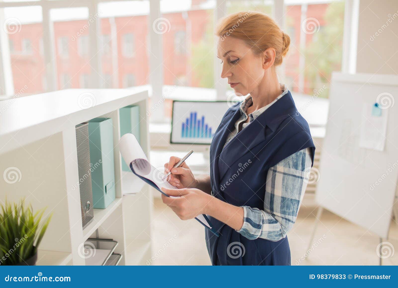 Pretty Manager Writing on Clipboard Stock Image - Image of office ...