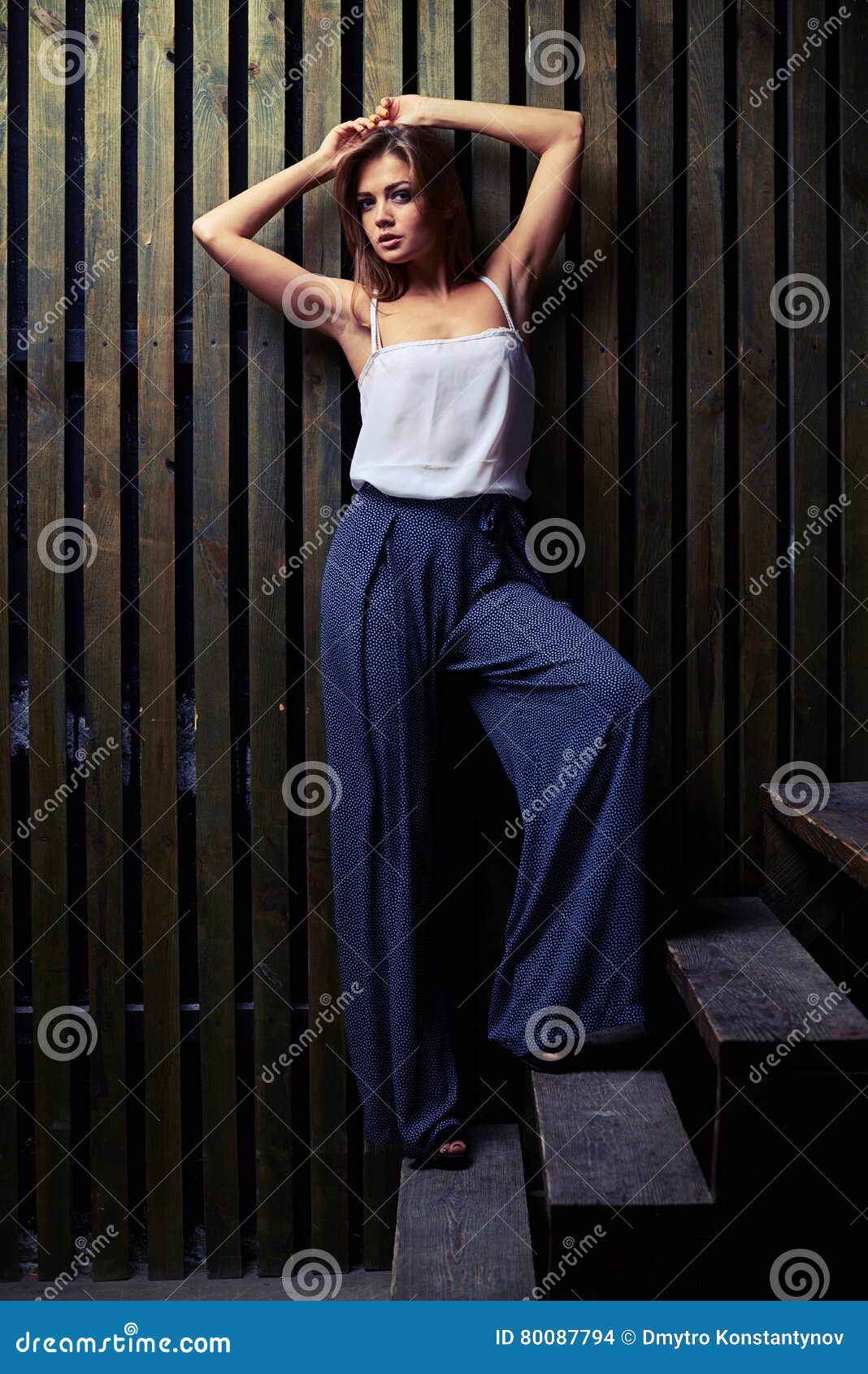 Pretty Model with Hands Up Leaning on the Wall while Posing at T Stock ...