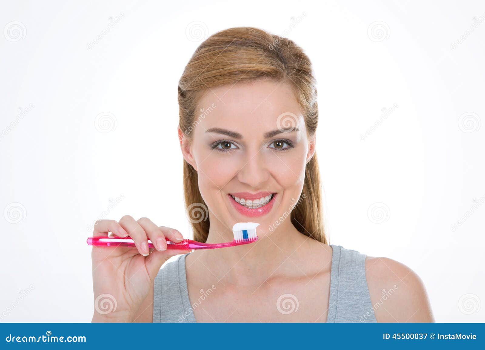 Pretty Model Holds Toothbrush Stock Image - Image of grey, expression ...