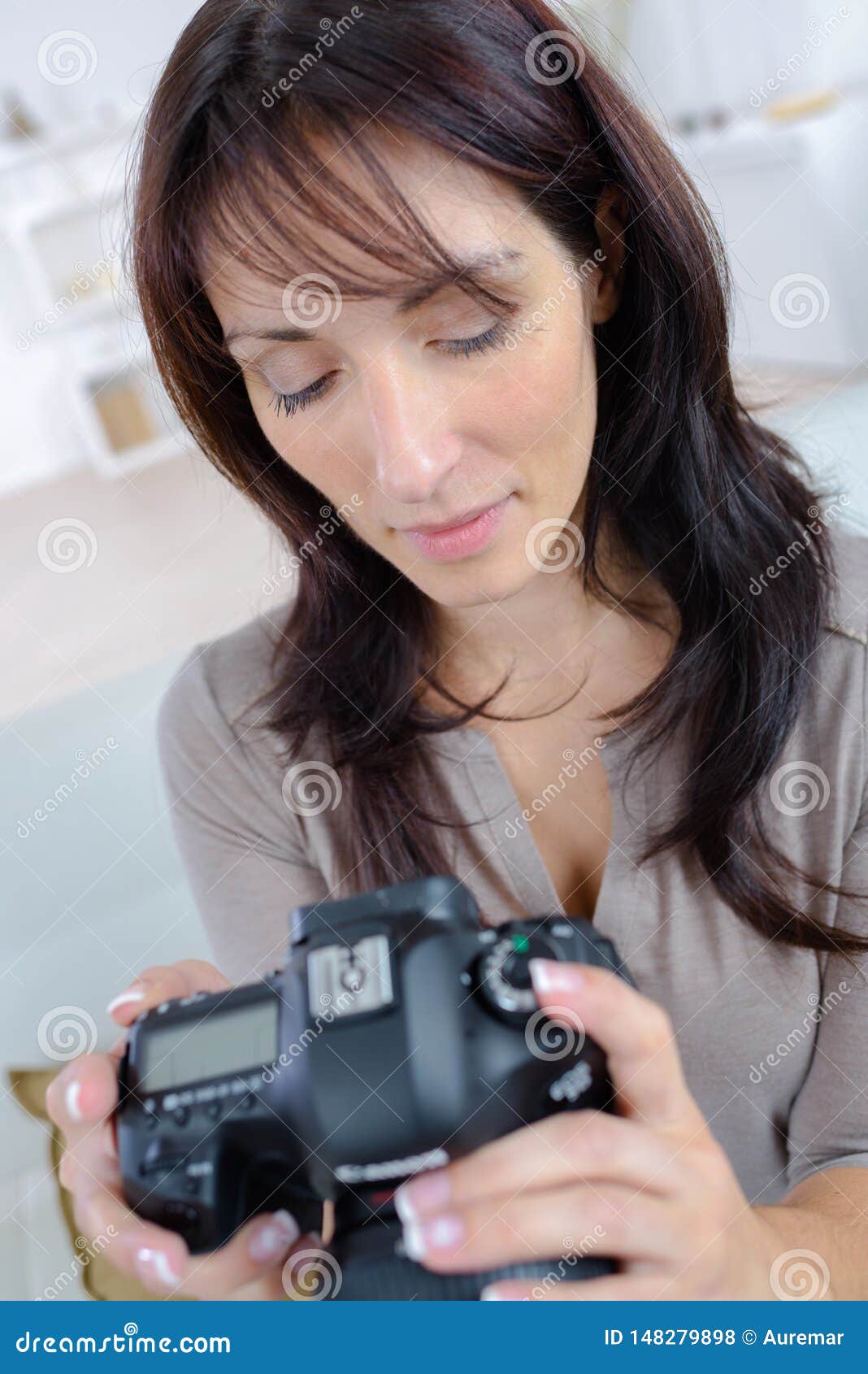 Pretty Photographer Holding Camera and Checking Photos Stock Photo ...