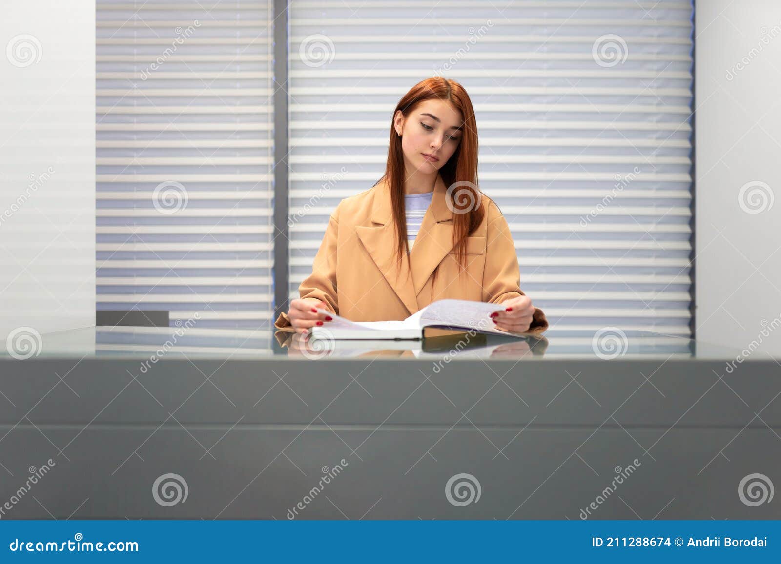 Pretty Receptionist Woman Flips through the Ledger. Stock Photo - Image ...