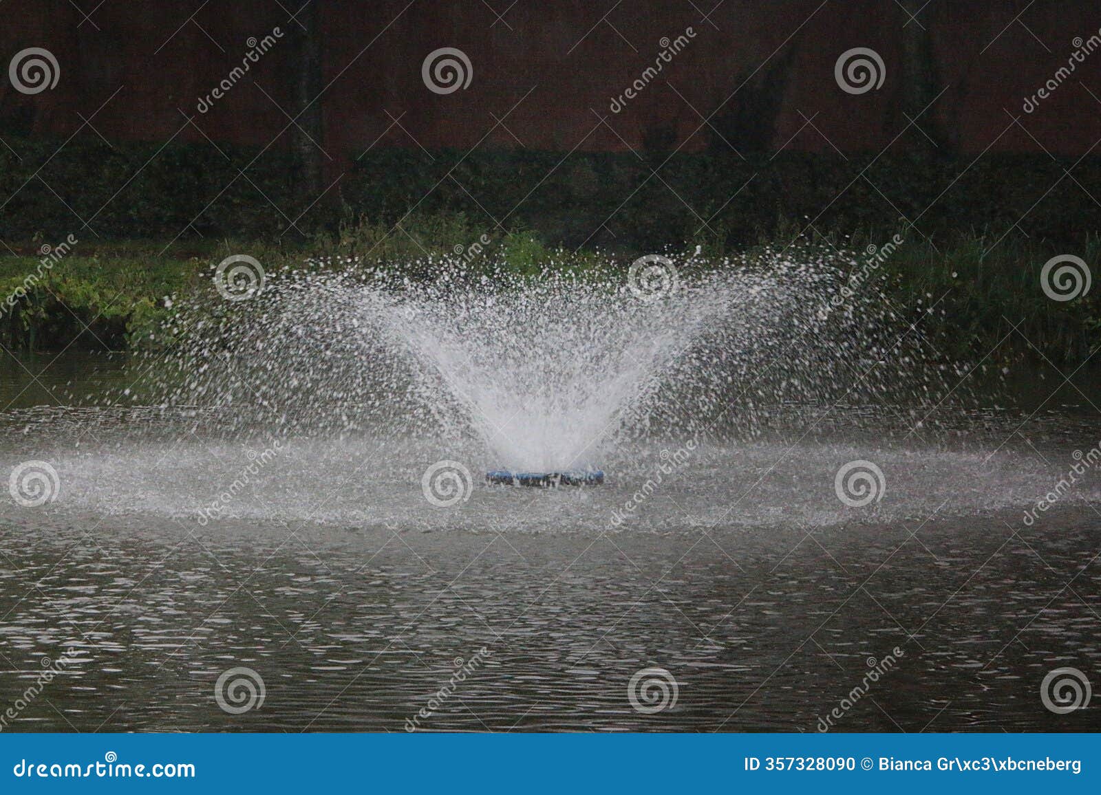 A Pretty Round Decorative Fountain on a Small Lake Stock Photo - Image ...