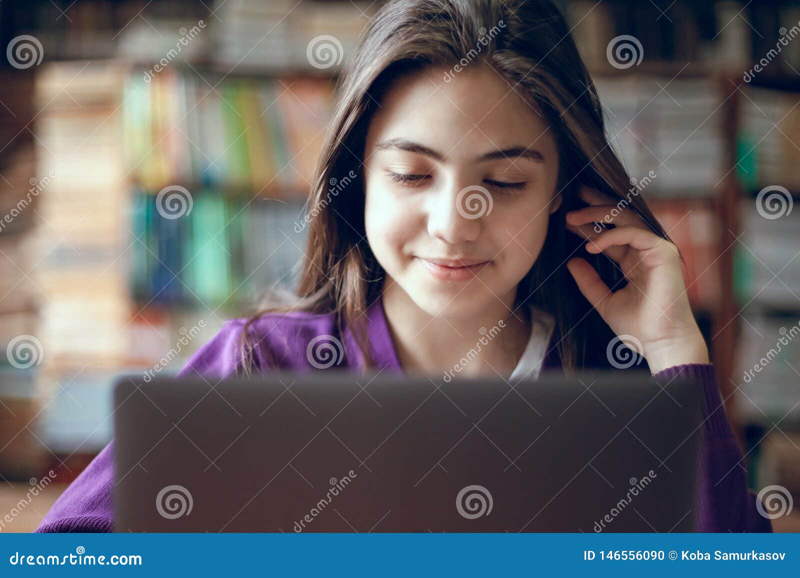 Pretty School Girl Studying in the School Library Using Laptop Stock ...
