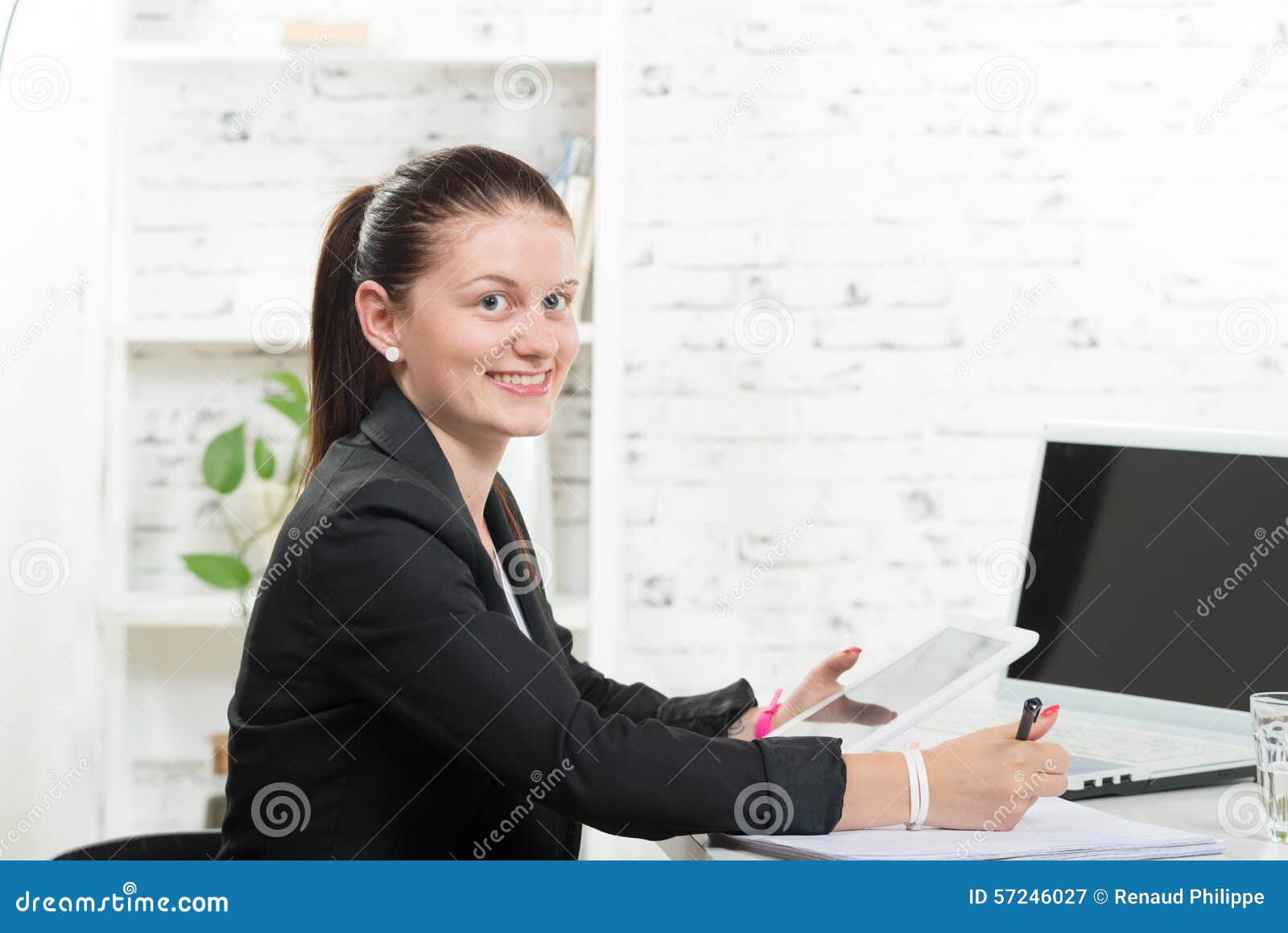 A Pretty Secretary Looking at a Digital Tablet Stock Image - Image of ...