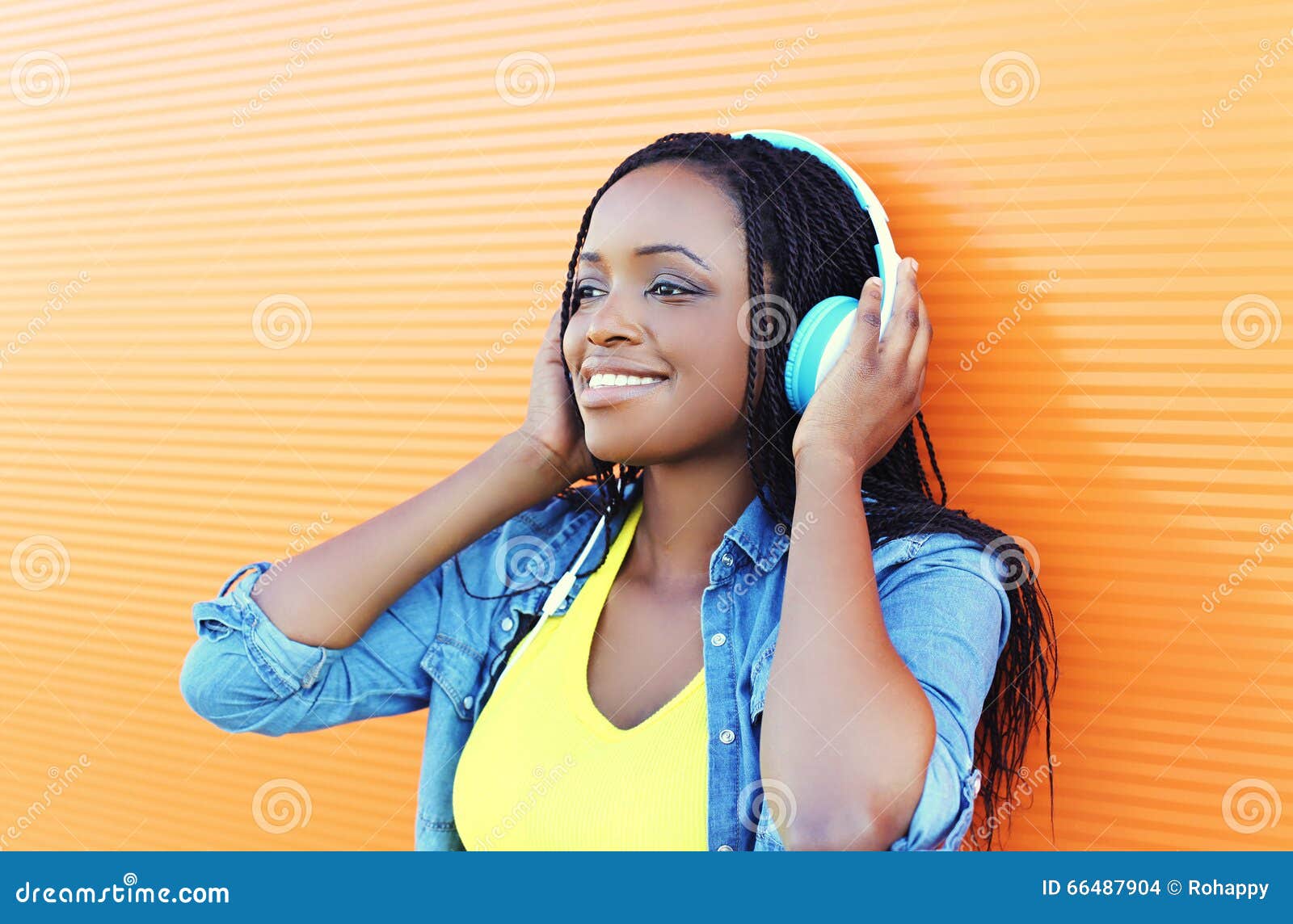 Pretty Smiling African Woman With Headphones Enjoying Listens To Music