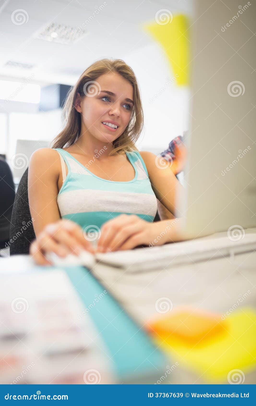 Pretty Smiling Girl Doing Assignment in the Computer Room Stock Image ...