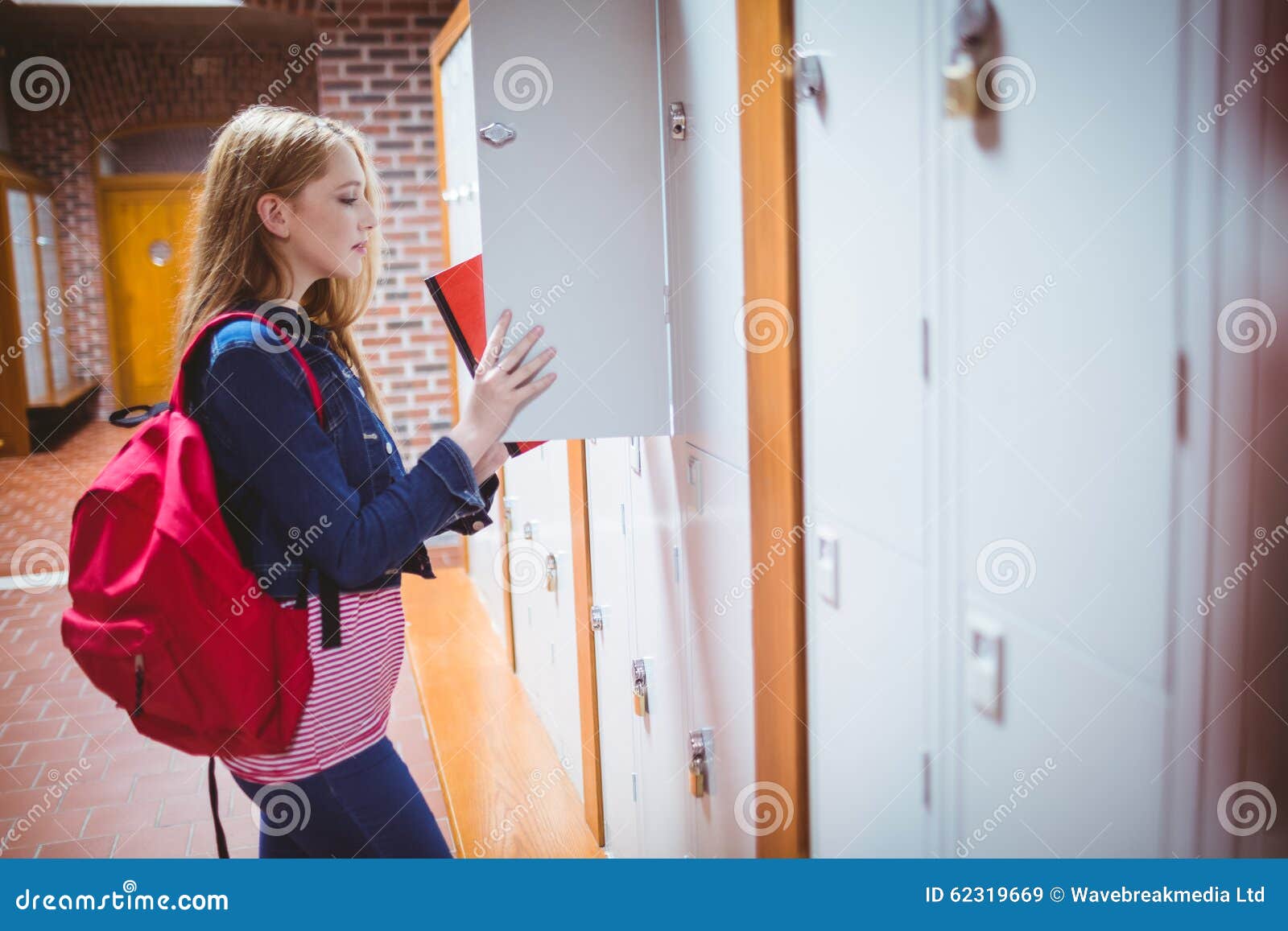 Pretty Student with Backpack Putting Notebook in the Locker Stock Image ...