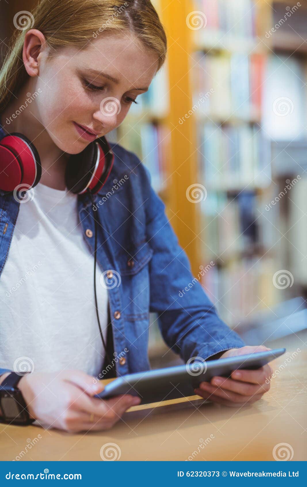 Pretty Student with Headphones Using Tablet in Library Stock Image ...