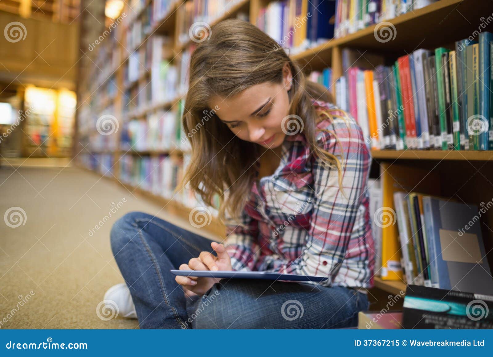 Pretty Student Sitting on Library Floor Using Tablet Stock Image ...