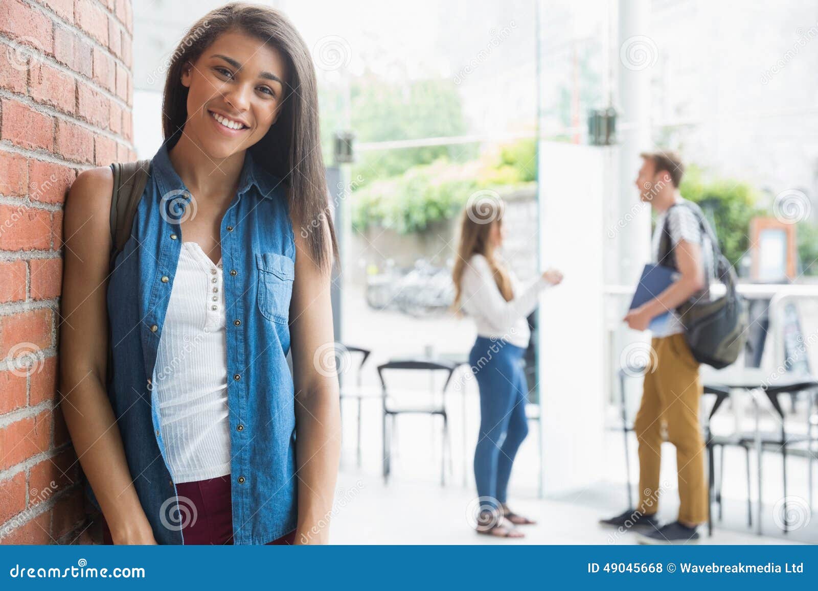Pretty Student Smiling at Camera with Classmates Behind Stock Photo ...