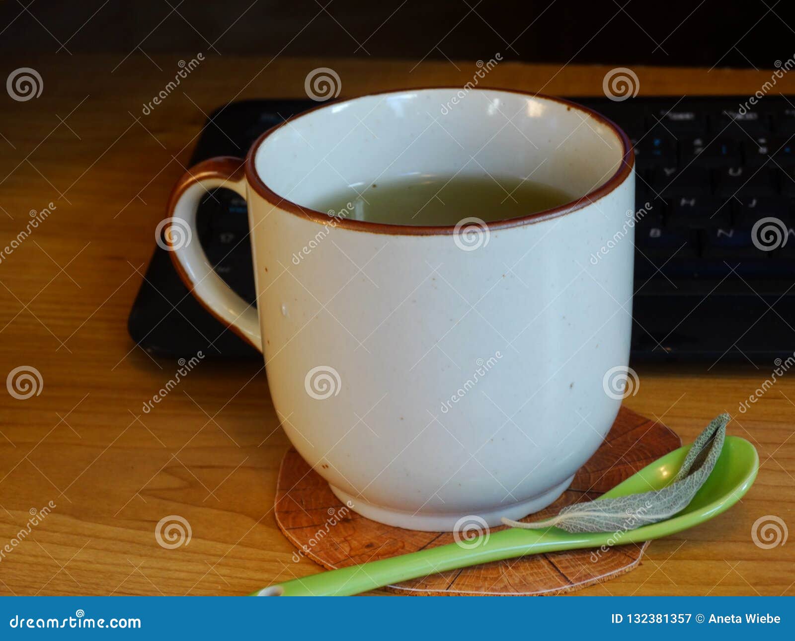 Pretty tea cup by keyboard stock image. Image of pretty - 132381357
