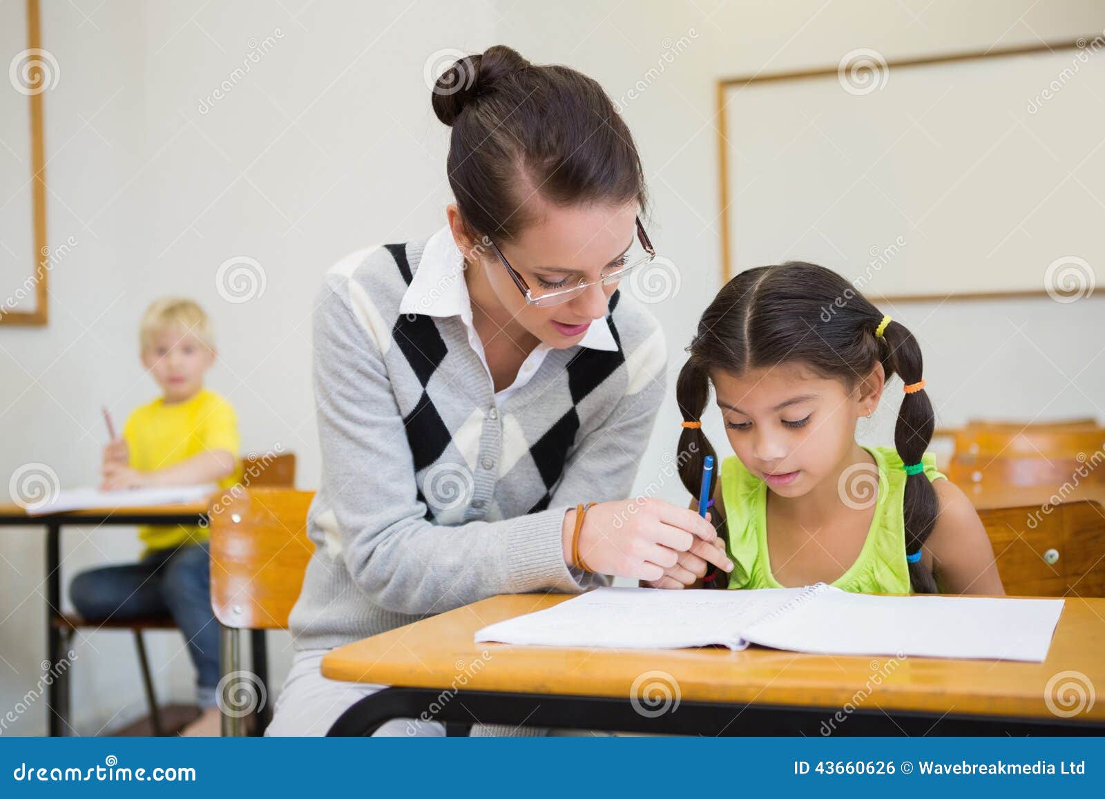 Pretty Teacher Helping Pupil in Classroom Stock Photo - Image of early ...