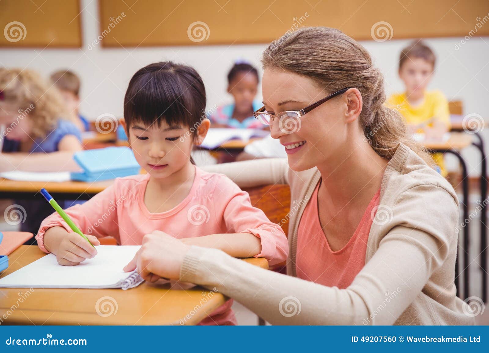 Pretty Teacher Helping Pupil in Classroom Stock Photo - Image of five ...