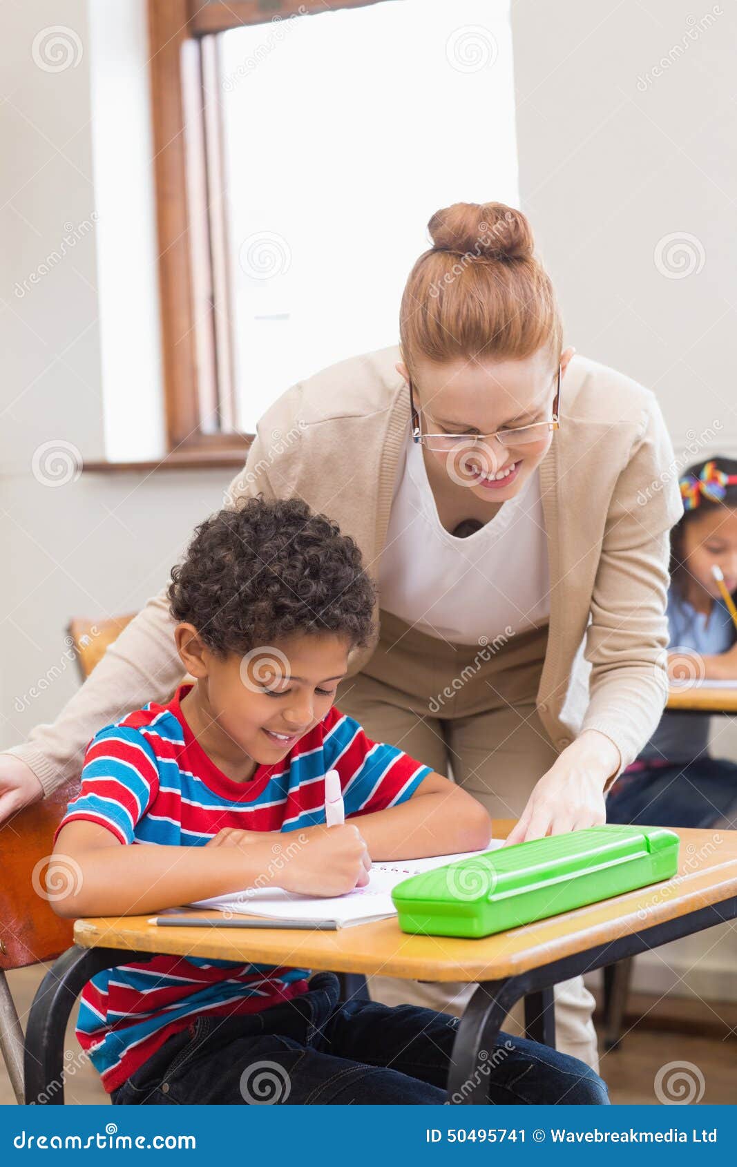 Pretty Teacher Helping Pupil in Classroom Stock Image - Image of happy ...