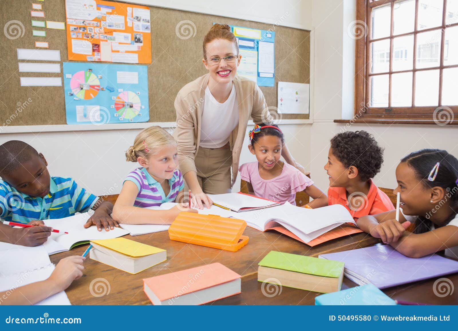 Pretty Teacher Helping Pupils in Classroom Stock Photo - Image of desk ...