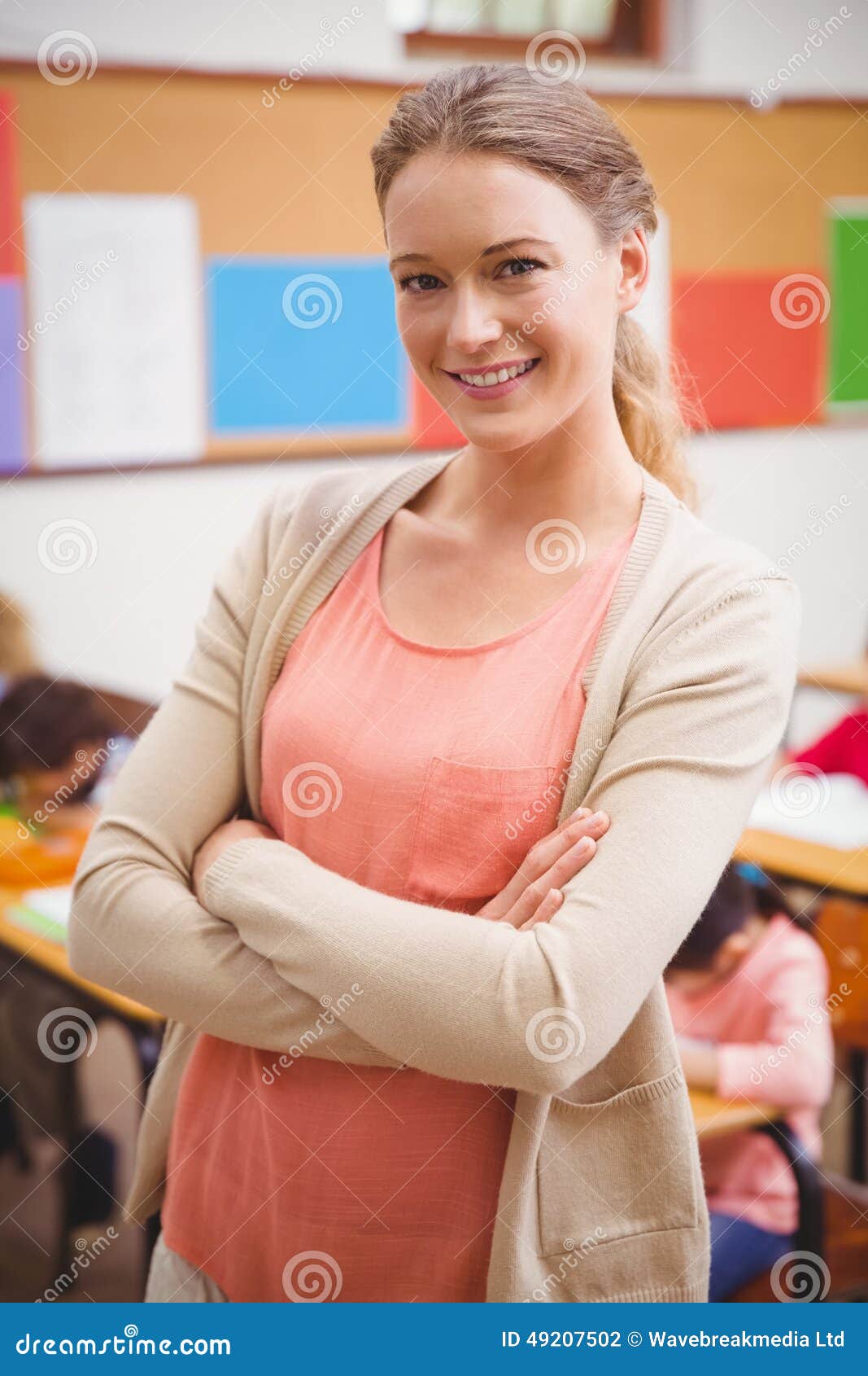 Pretty Teacher Smiling at Camera at Top of Classroom Stock Photo ...