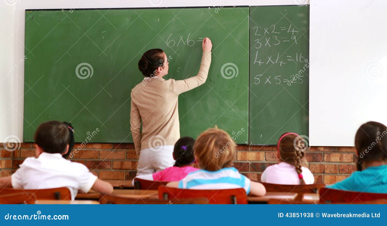 Pretty Teacher Teaching Math To Her Class and Smiling at Camera Stock ...
