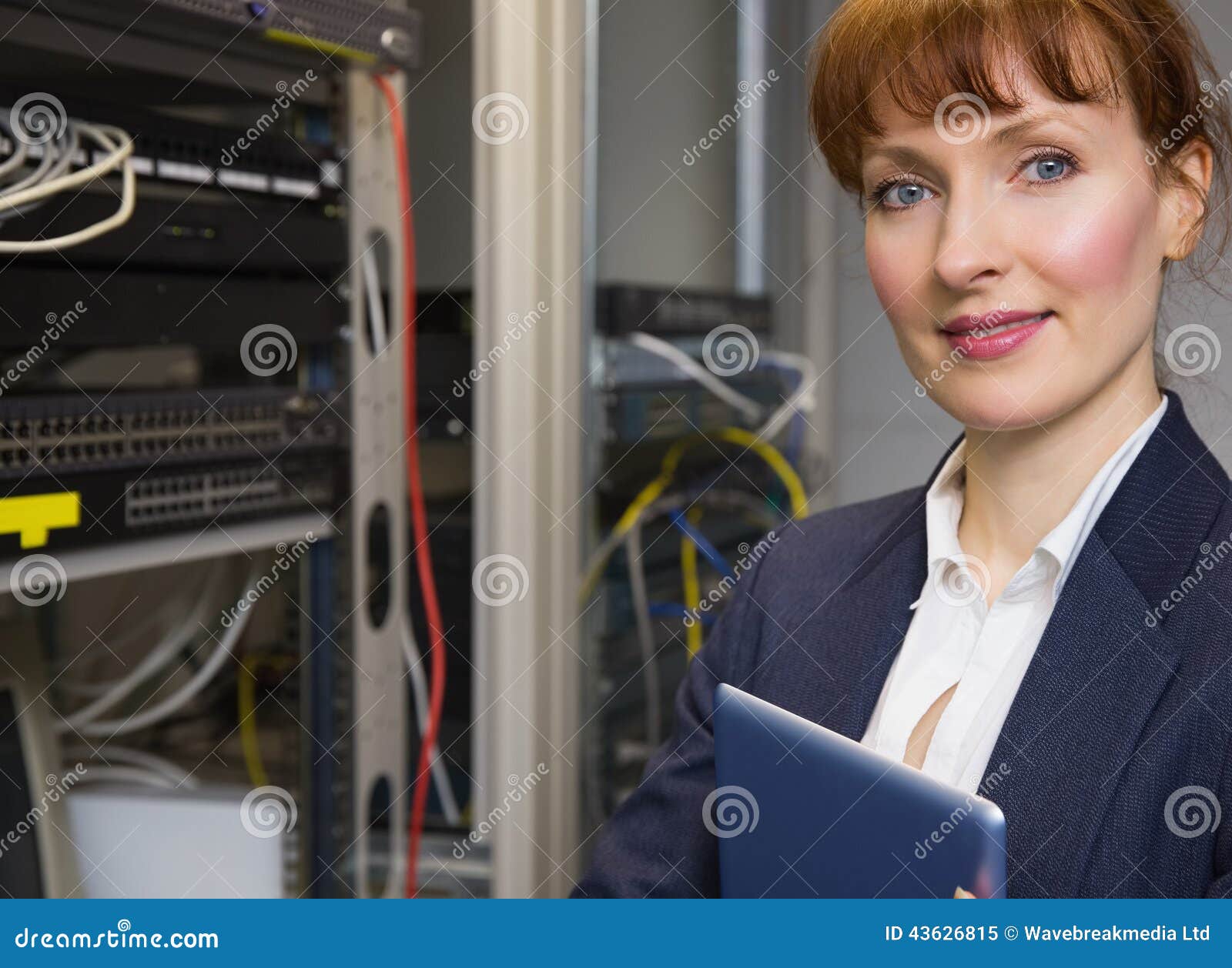 Pretty Technician Smiling at Camera beside Open Server Holding Tablet ...