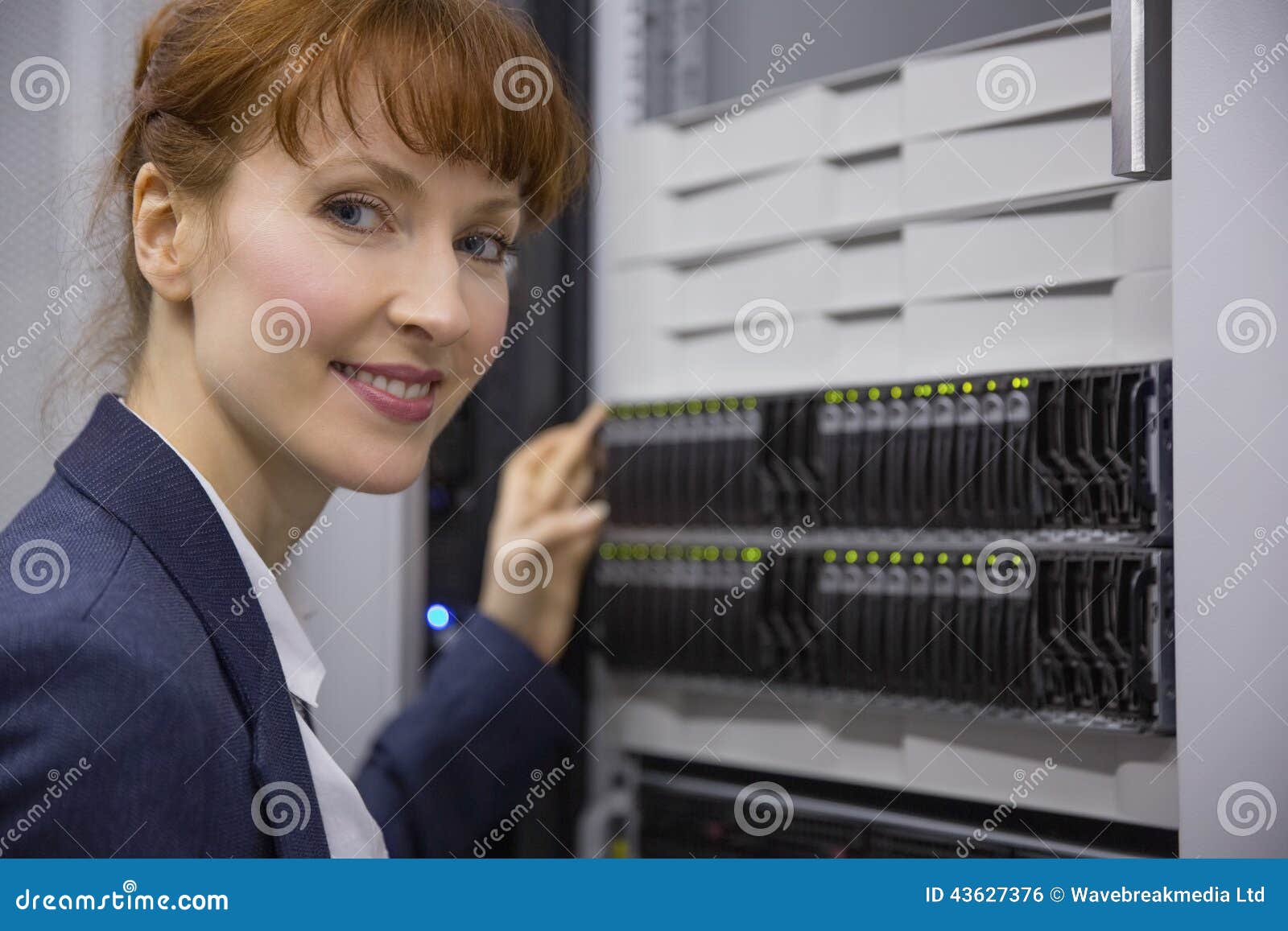 Pretty Technician Smiling at Camera beside Server Tower Stock Photo ...