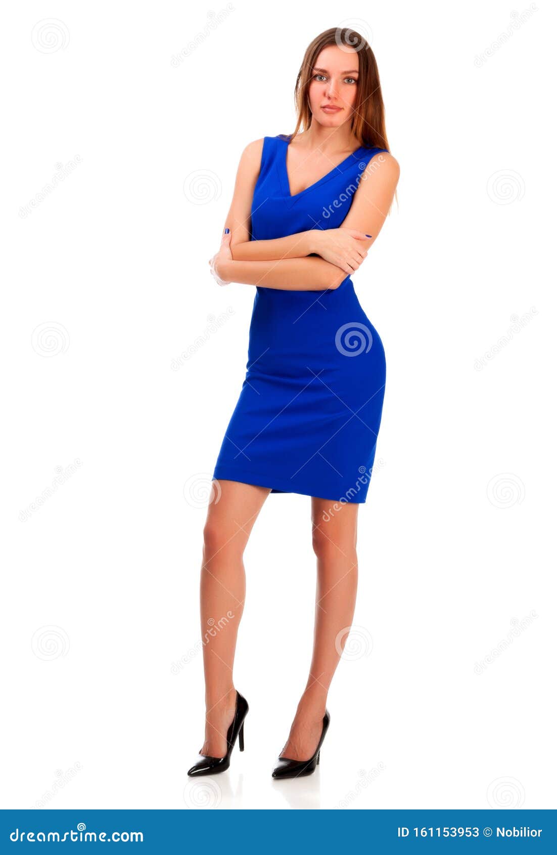 Pretty Woman In Blue Dress Posing Against White Background Stock Image