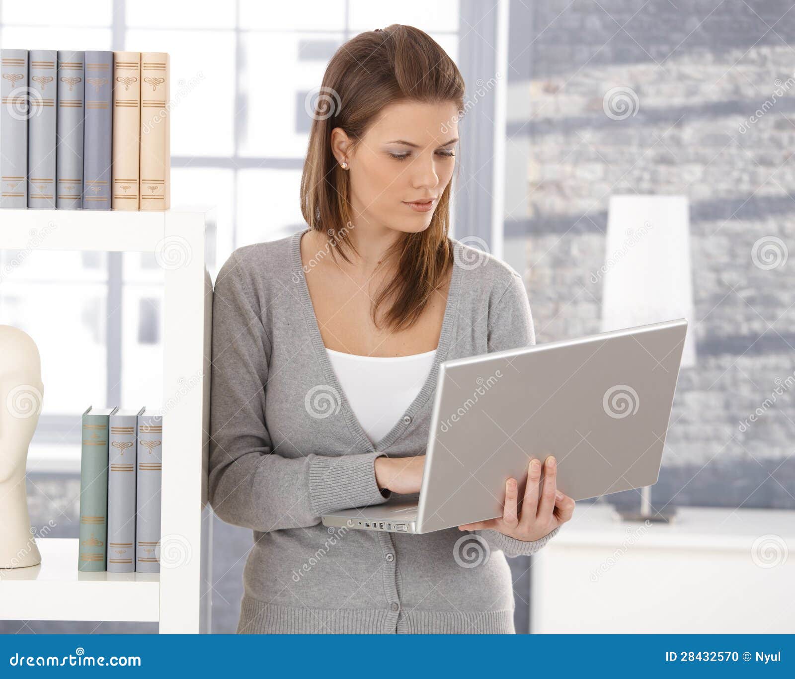 Pretty Woman by Bookshelf with Computer Stock Photo - Image of focusing ...