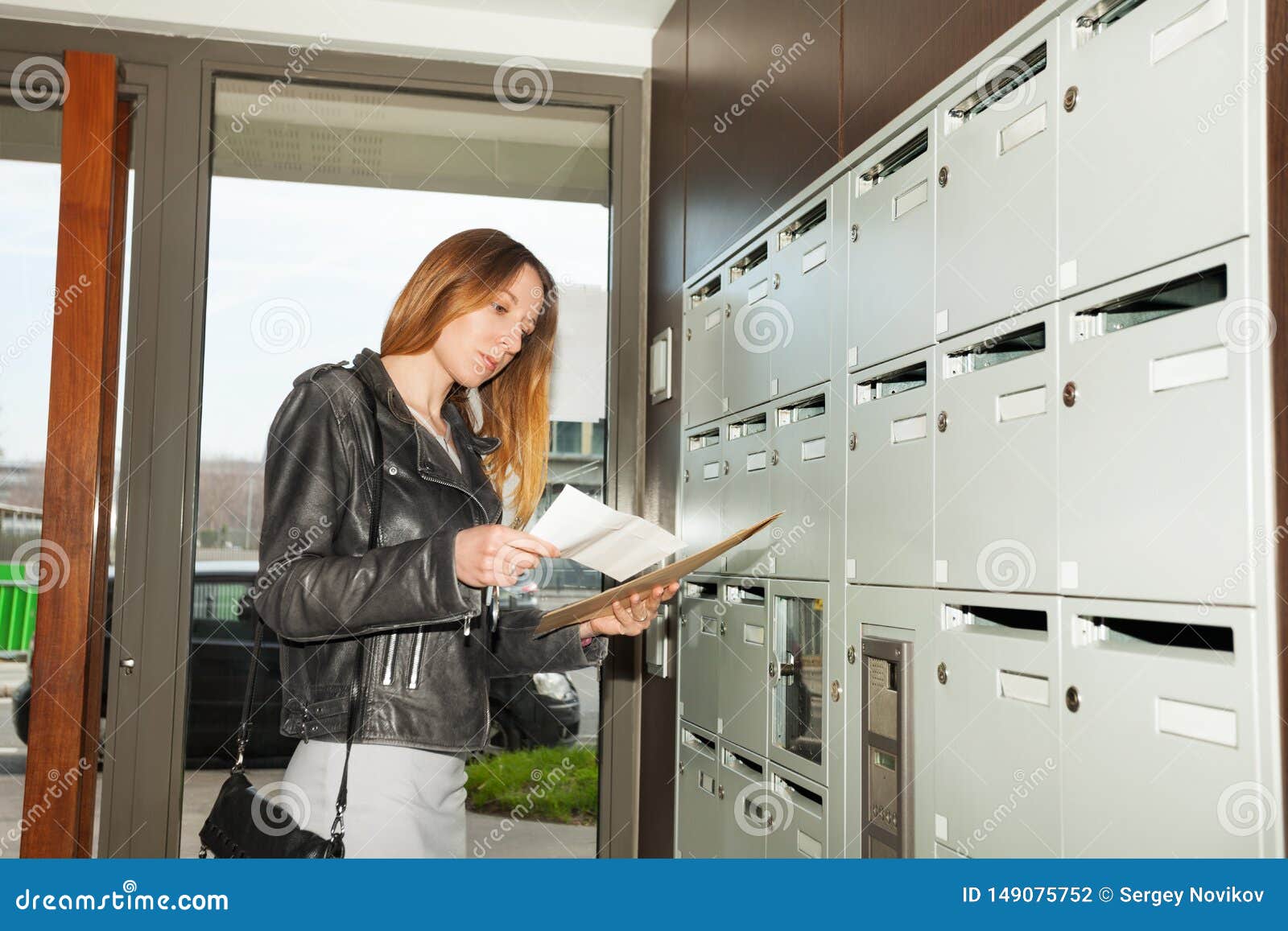 Pretty Woman Checking Junk Mail Standing at a Hall Stock Photo - Image ...