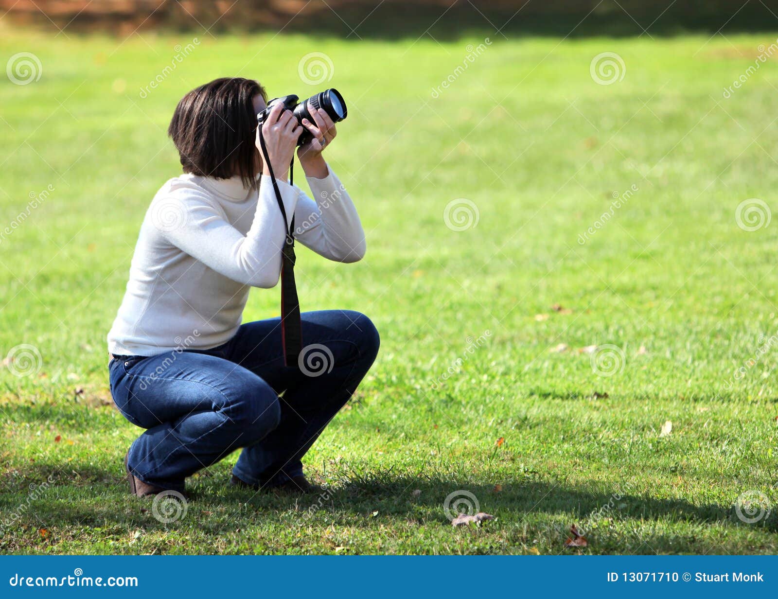 Pretty Woman Crouching with Camera Stock Photo - Image of dslr ...