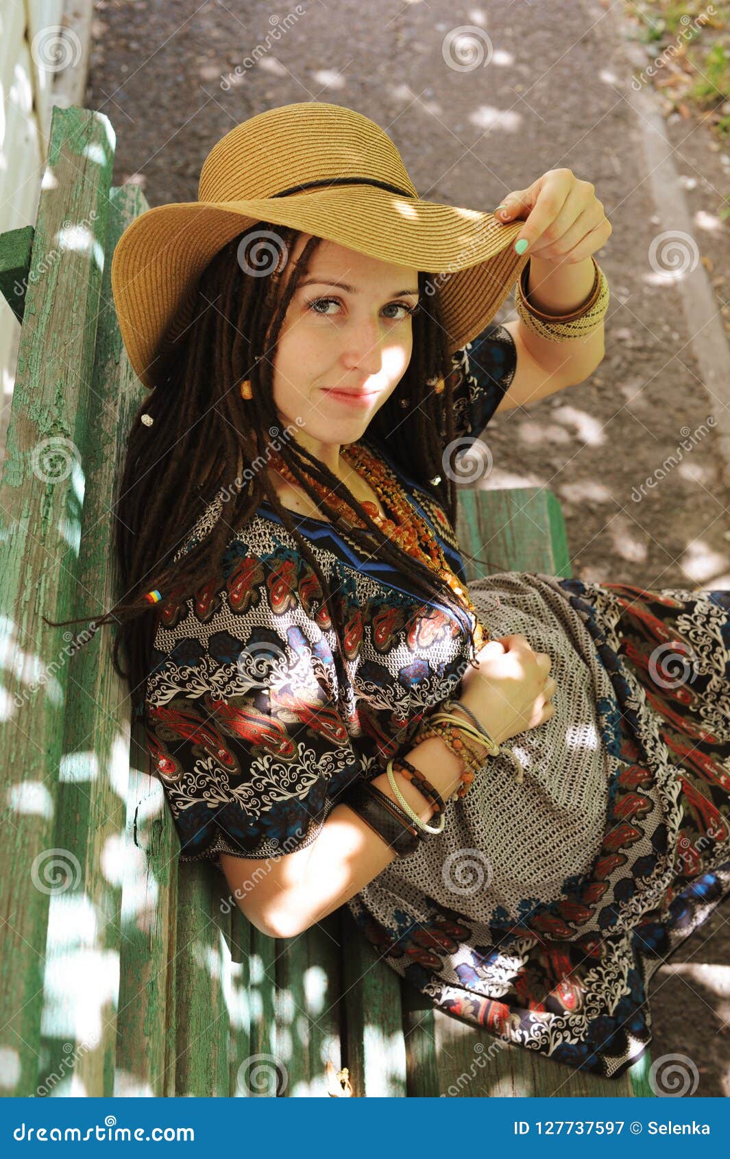 Pretty Woman With Dreadlocks Dressed In Boho Style Dress And Hat Stock
