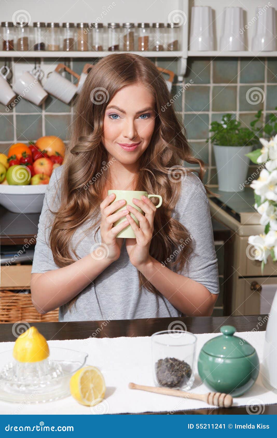 Pretty woman drinking tea stock image. Image of health - 55211241
