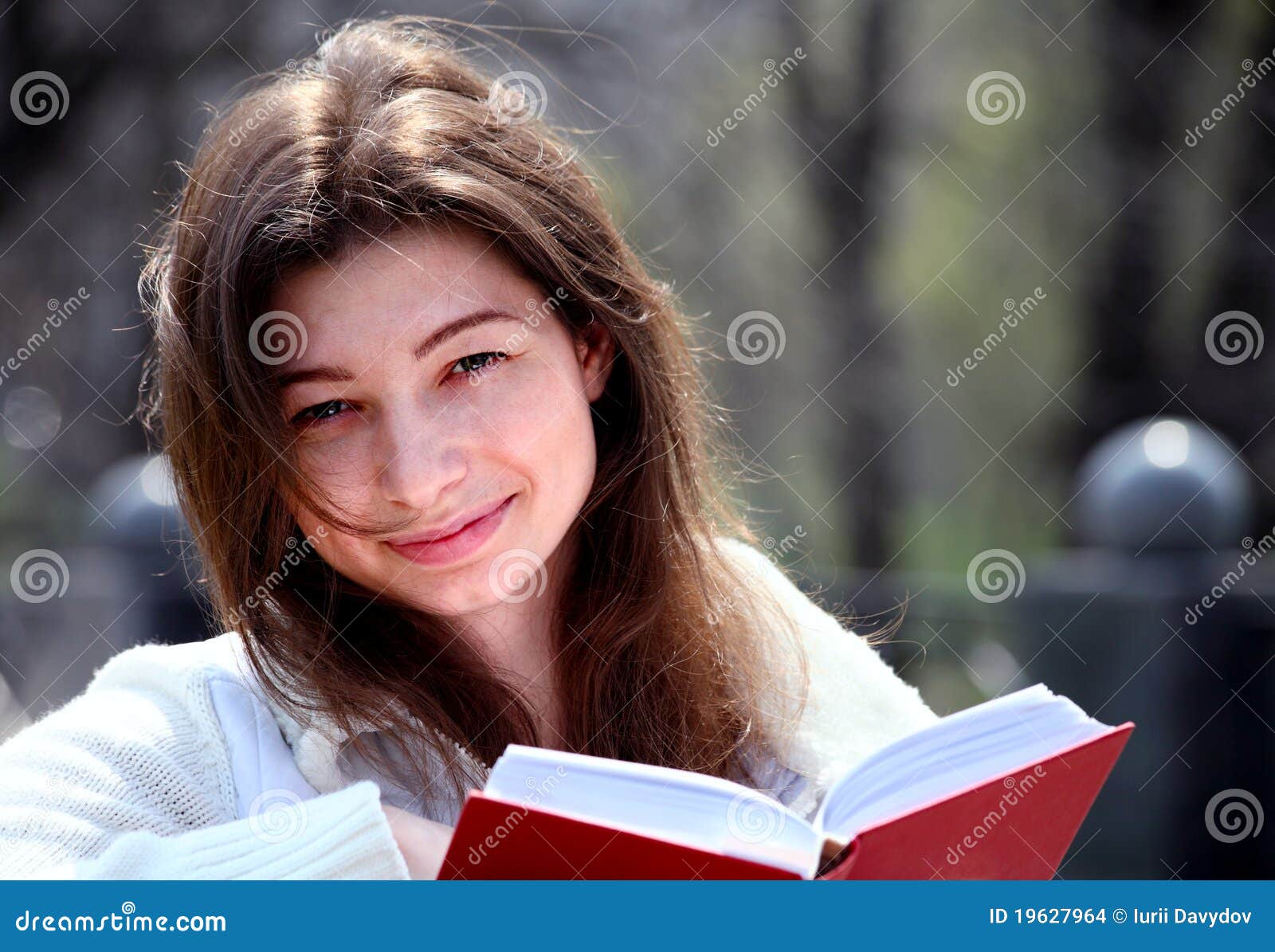 Pretty Woman in Park Reading Book and Smiling Stock Photo - Image of ...