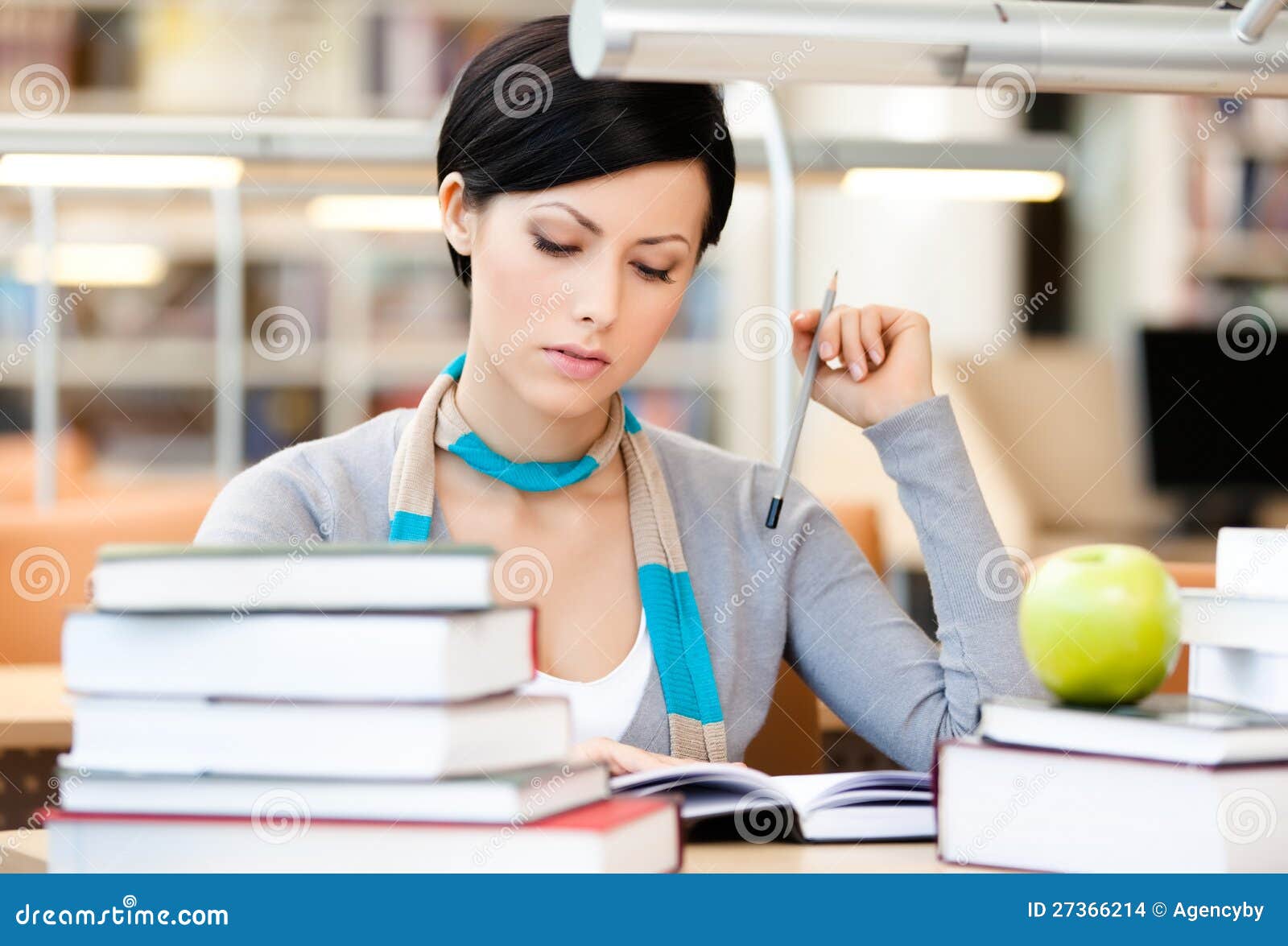 Pretty Woman Reads Sitting at the Desk Stock Photo - Image of busy ...
