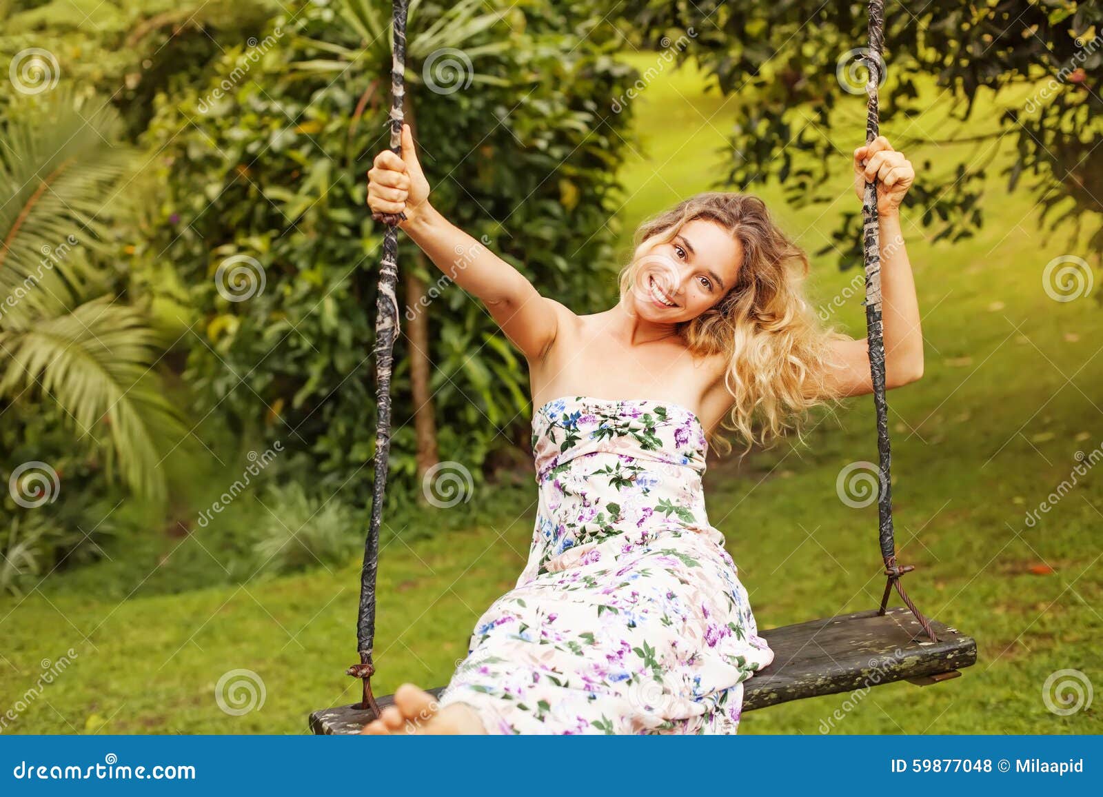 Pretty woman on a swing stock photo. Image of nature - 59877048