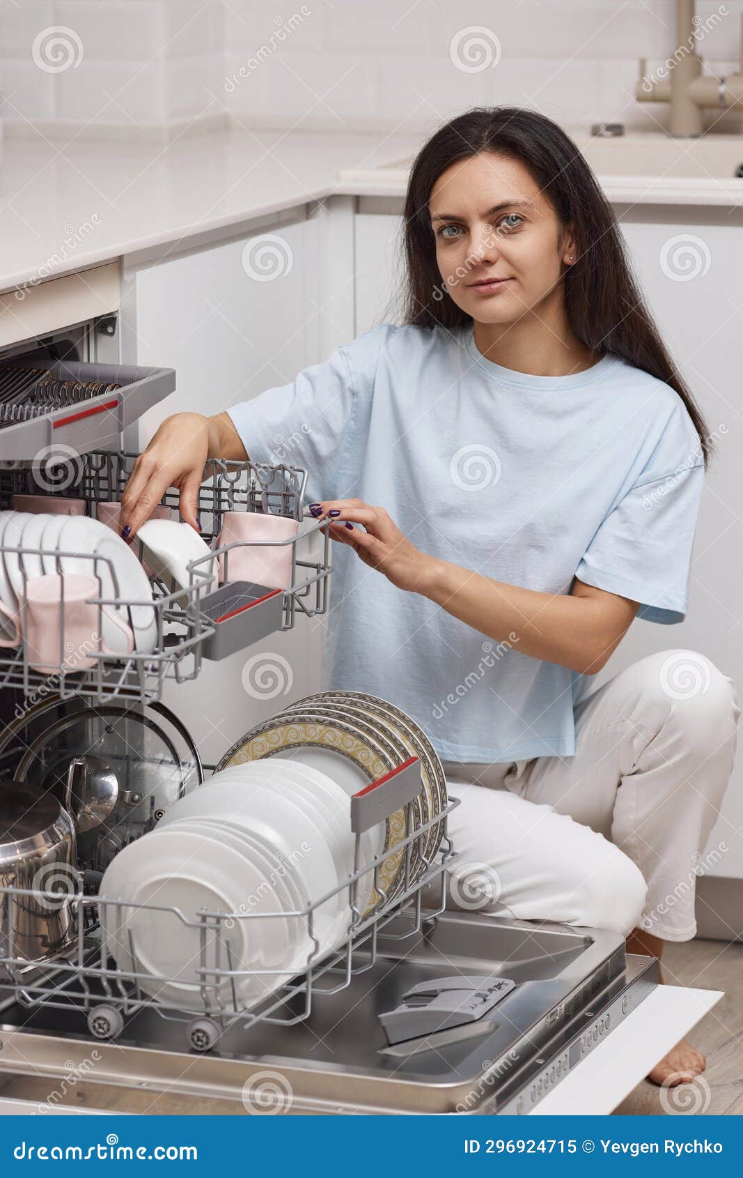 Pretty Woman Unloading from Open Dishwasher Machine with Clean Utensils ...