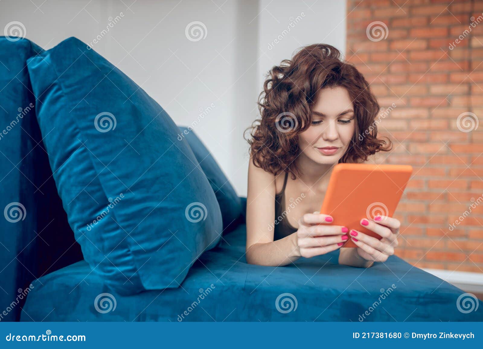 Pretty Woman Watching Something Online and Looking Interested Stock ...