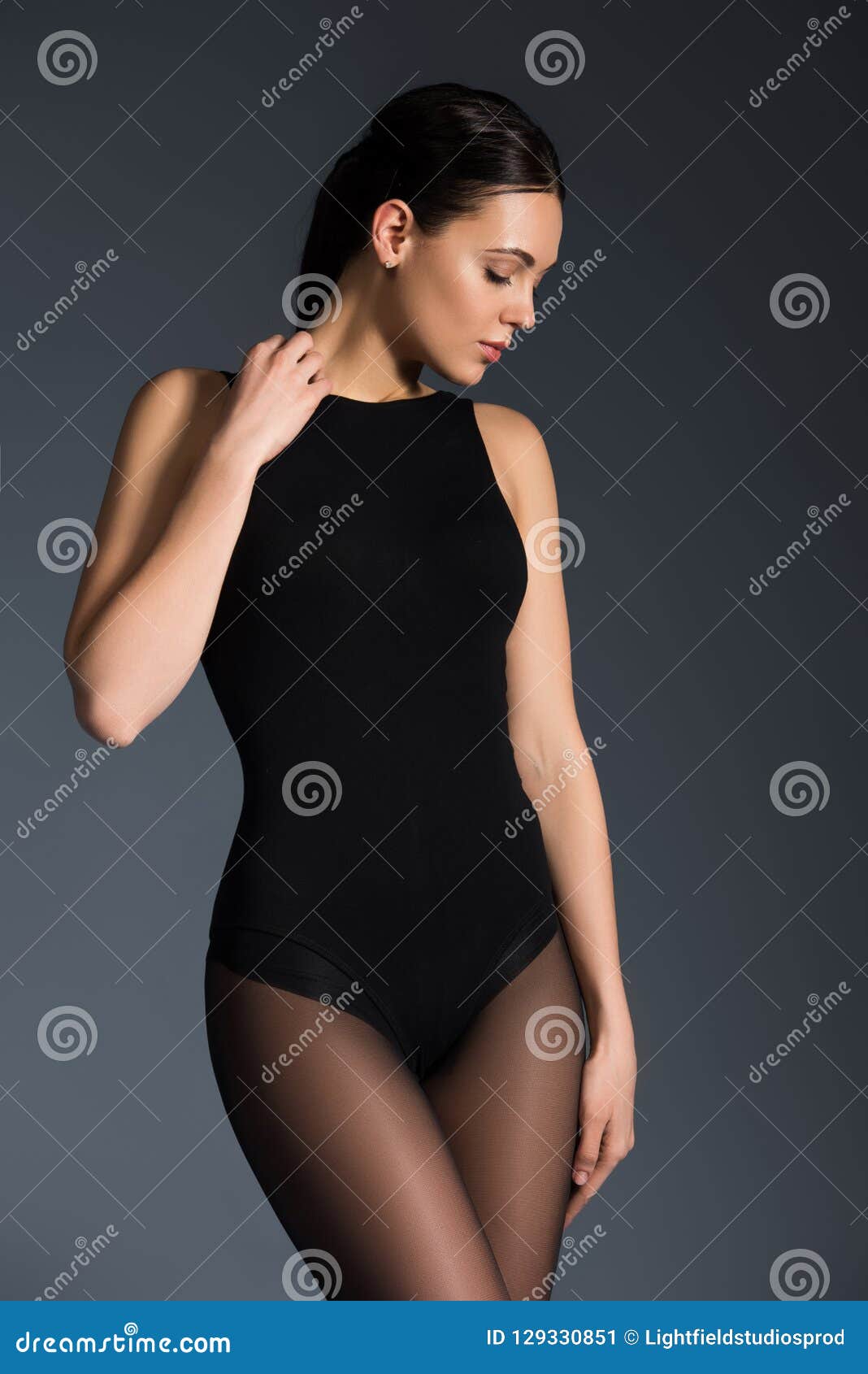 Pretty Woman Wearing Black Pantyhose And Bodysuit Posing Stock Image