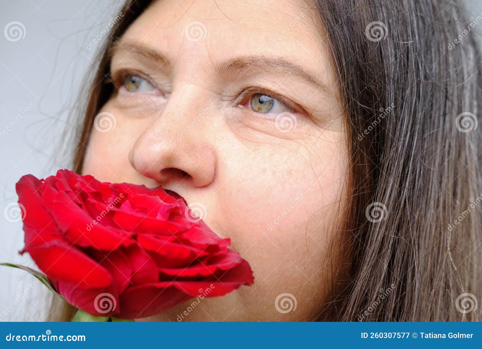 Pretty Woman 50 55 Years Old Closeup Red Rose Near Mature Female Face Slight Smile On Lips