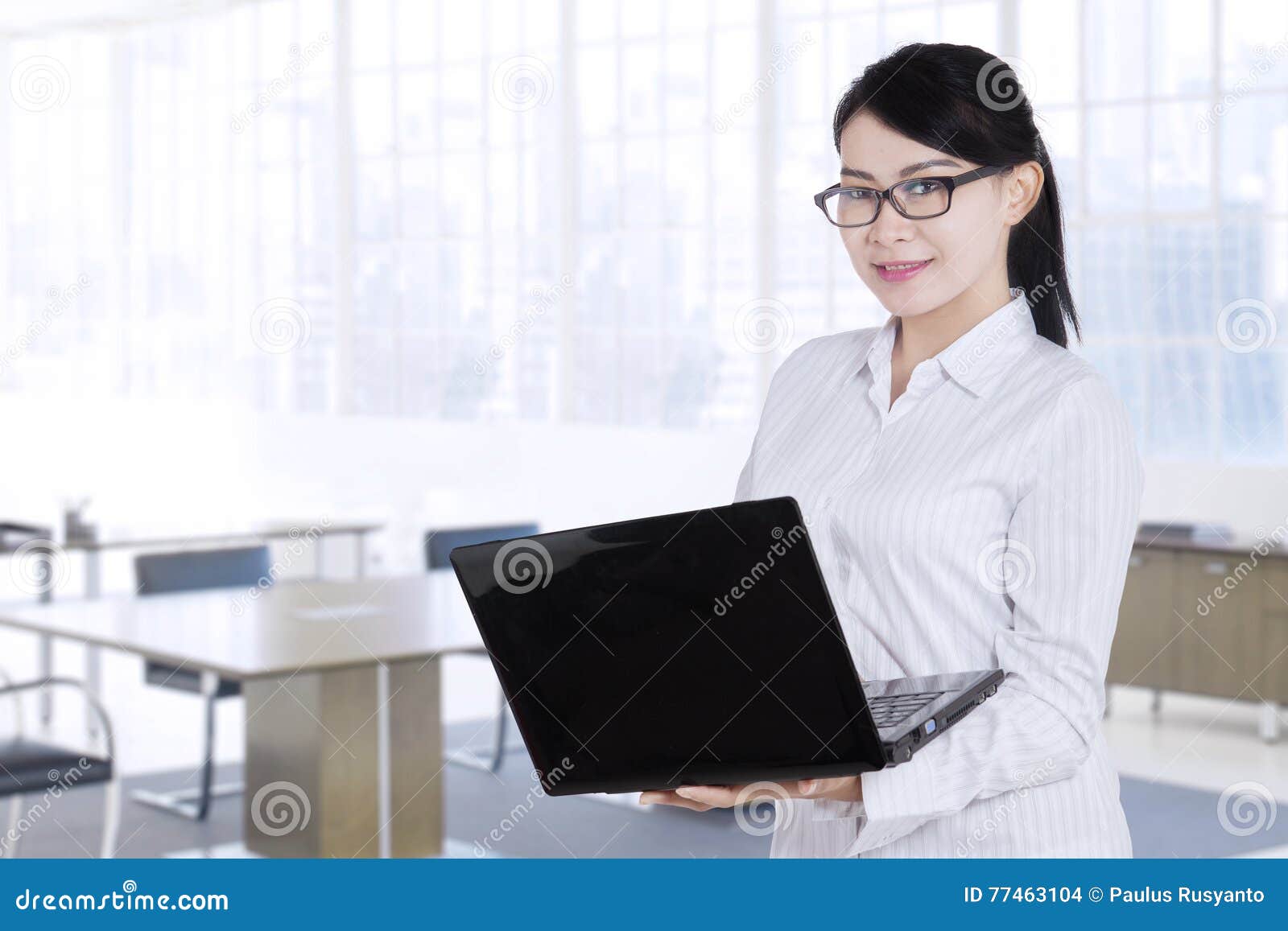 Pretty Worker Standing in Office with Laptop Stock Photo - Image of ...