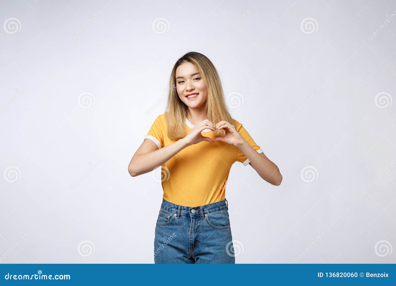 Pretty Young Asian Woman Making A Heart Gesture With Her Fingers In