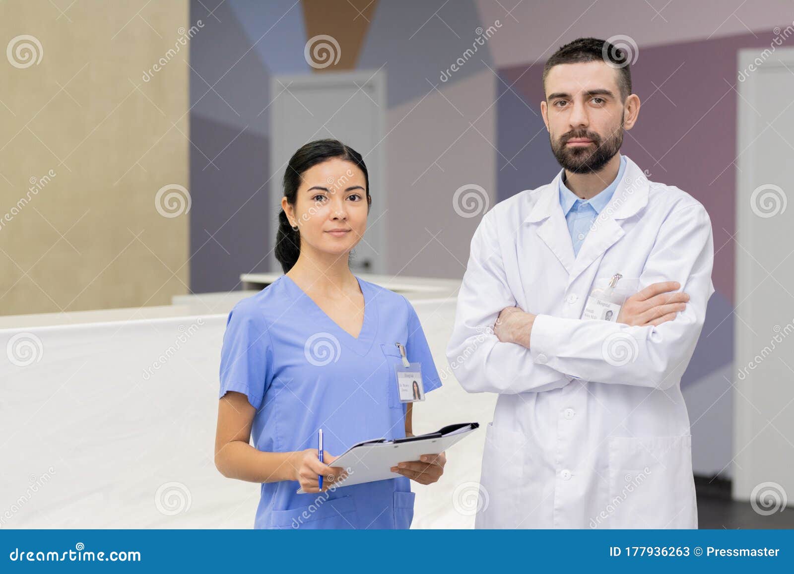 Pretty Young Assistant in Blue Uniform and Confident Dentist in ...