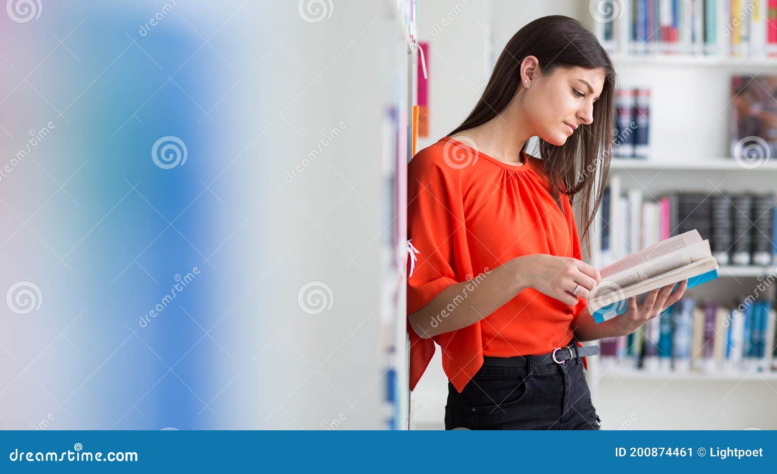 Pretty, Young College Student Looking for a Book in the Library Stock ...