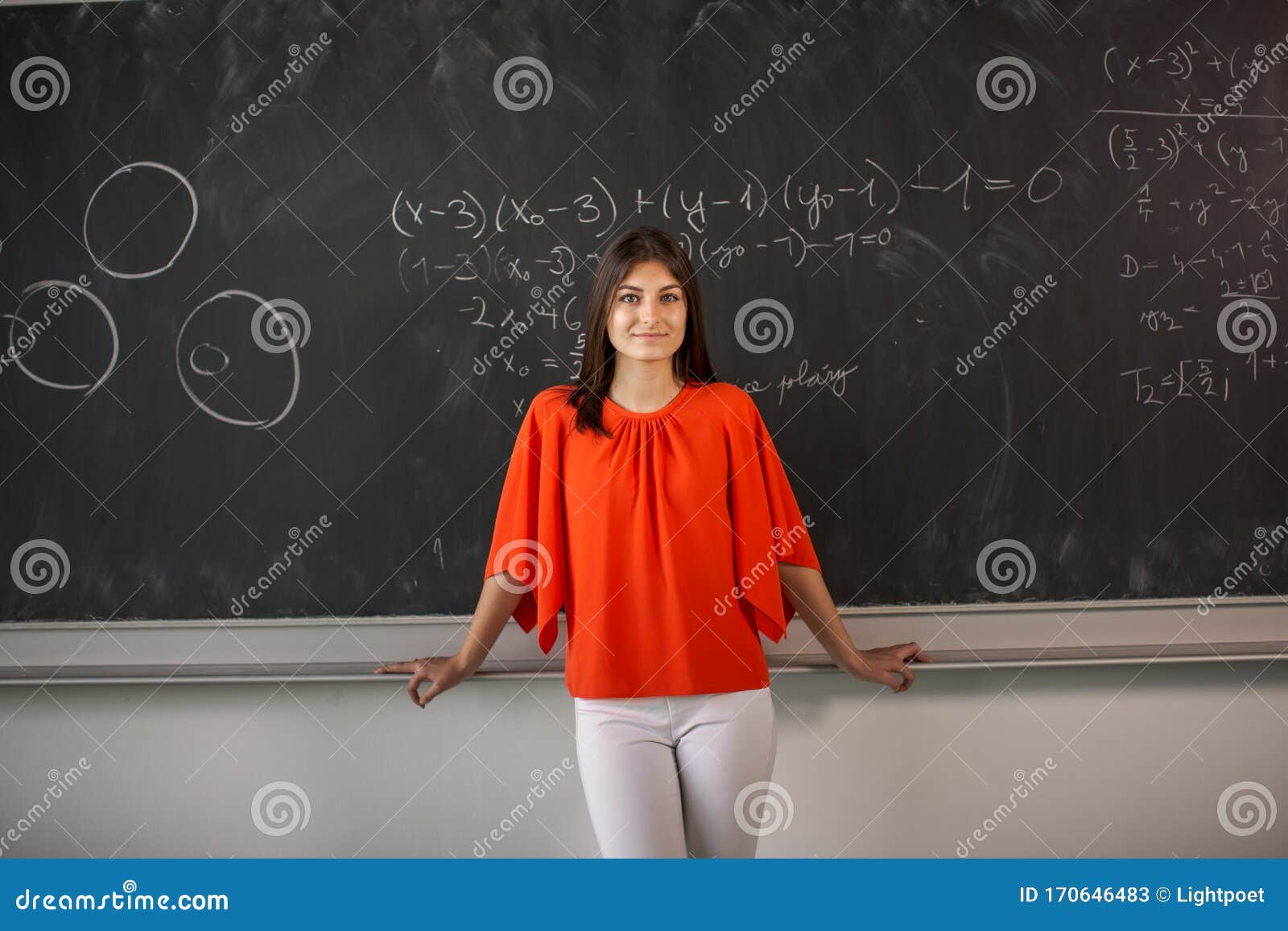 Pretty, Young College Student/young Teacher Writing on the Chalkboard ...