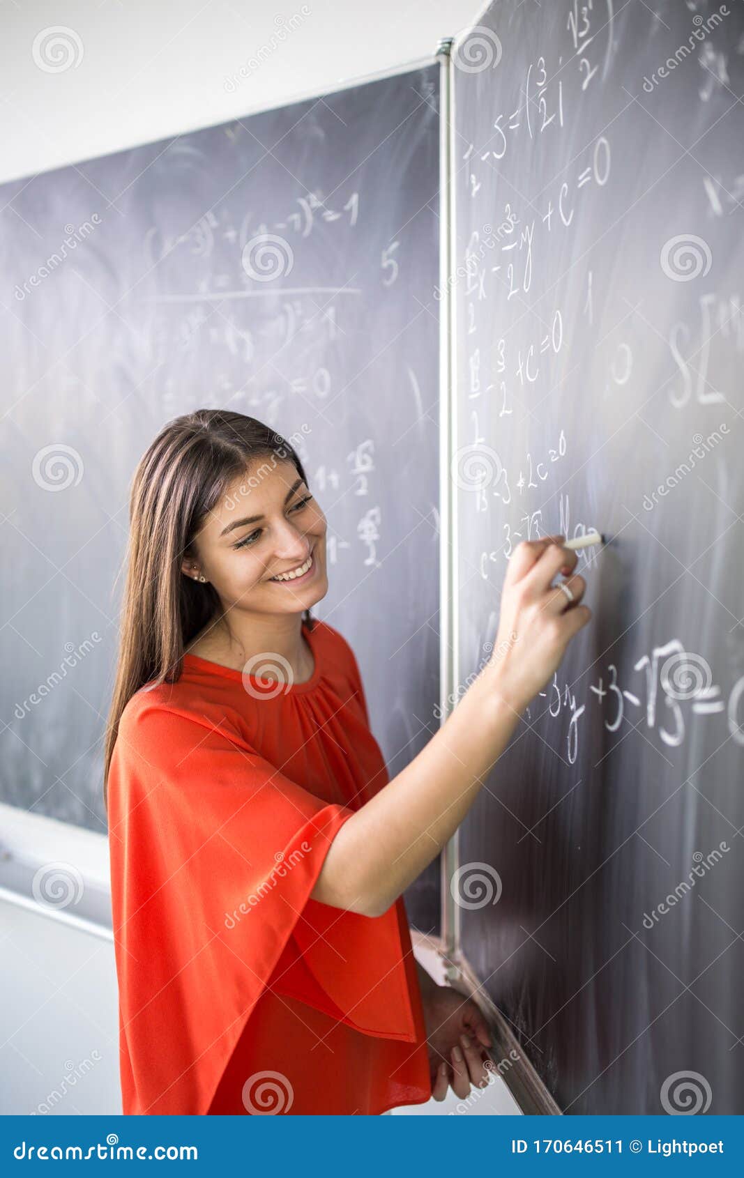 Pretty, Young College Student/young Teacher Writing on the Chalkboard ...