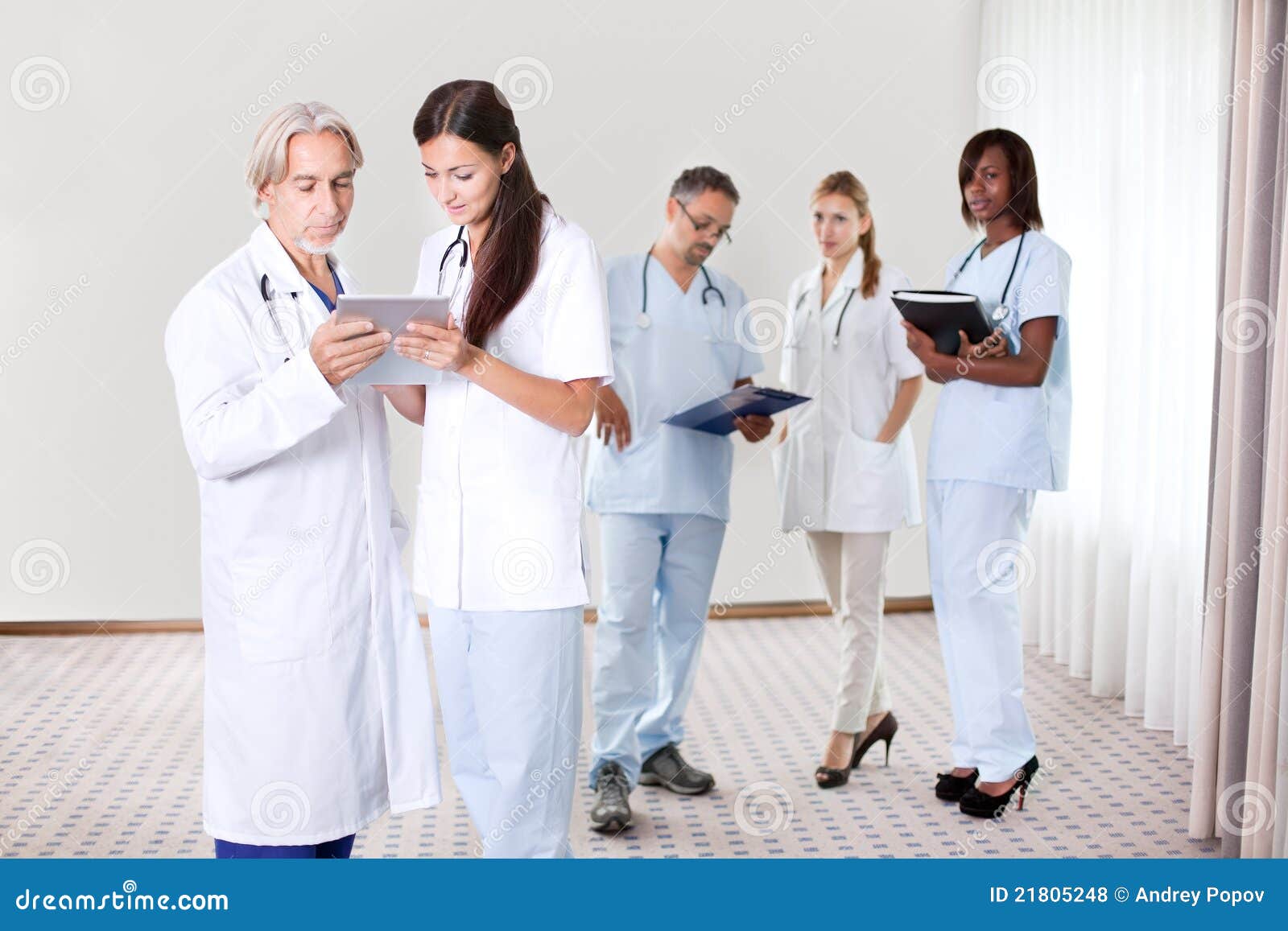 Pretty Young Doctors Looking at a File Stock Photo - Image of exam ...