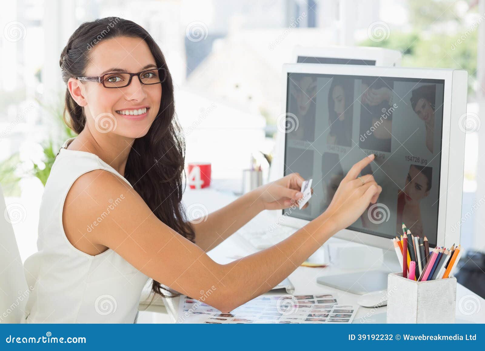 Pretty Young Editor Working at Her Desk Smiling at Camera Stock Photo ...